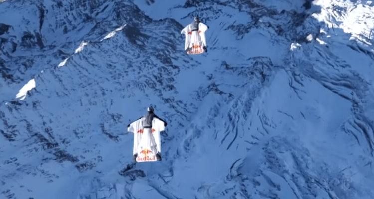 VIDEO: Two wingsuit flyers jump from top of mountain into a flying plane